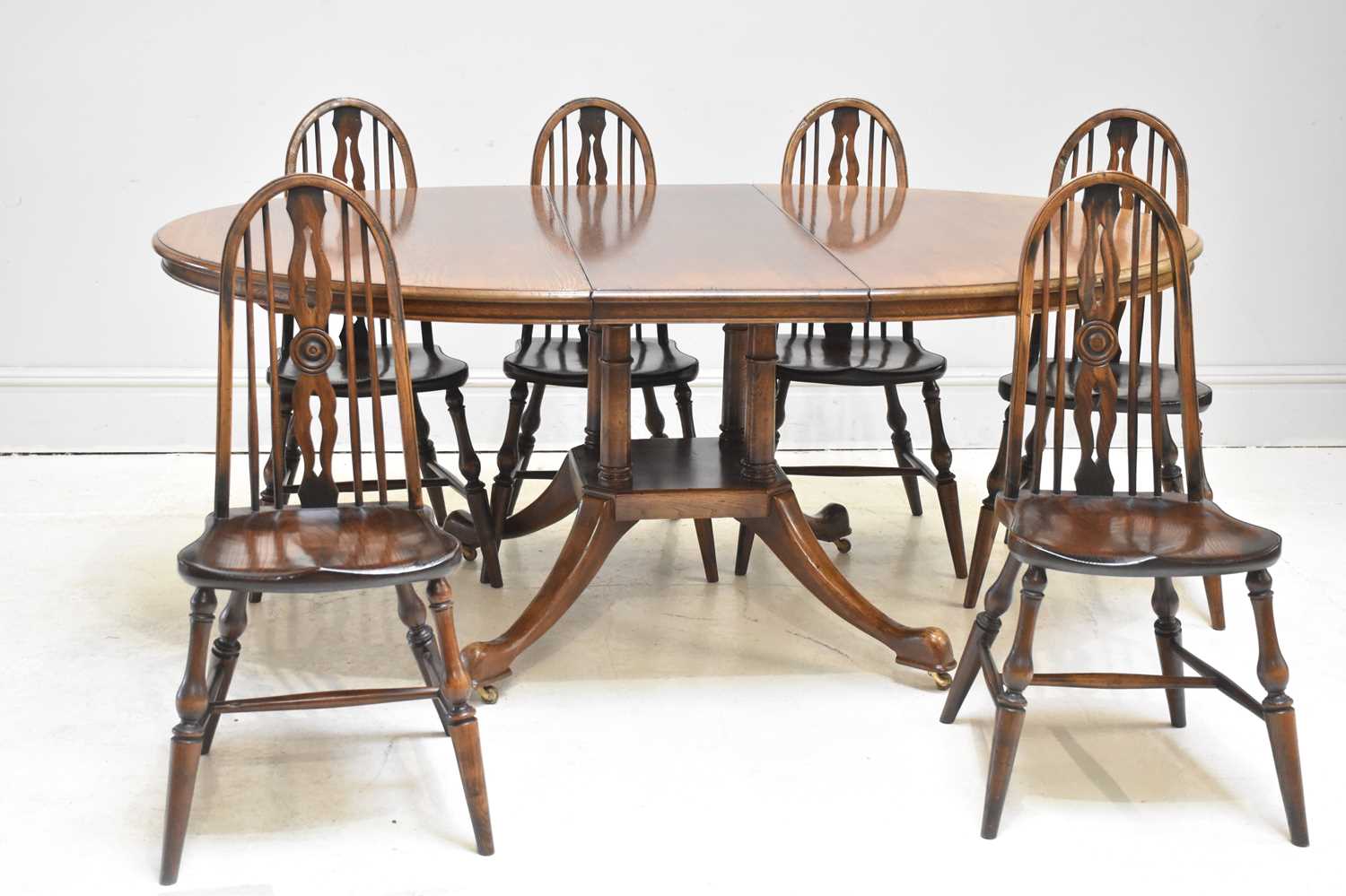 Lot 126 - A reproduction oak extending dining table,