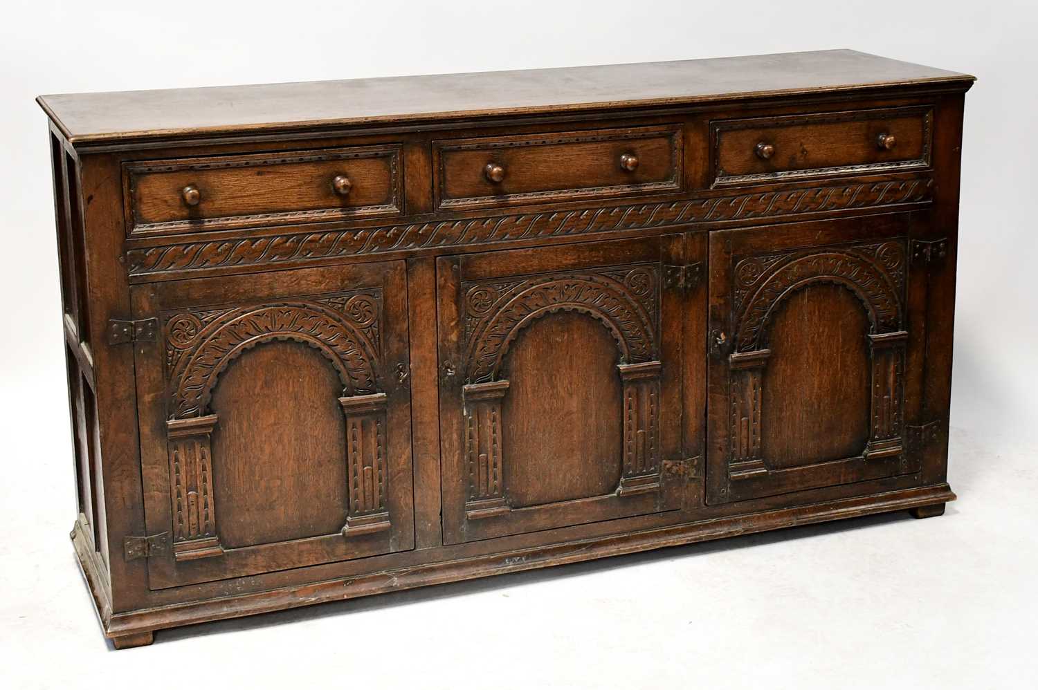 Lot 31 - An oak reproduction sideboard, three single