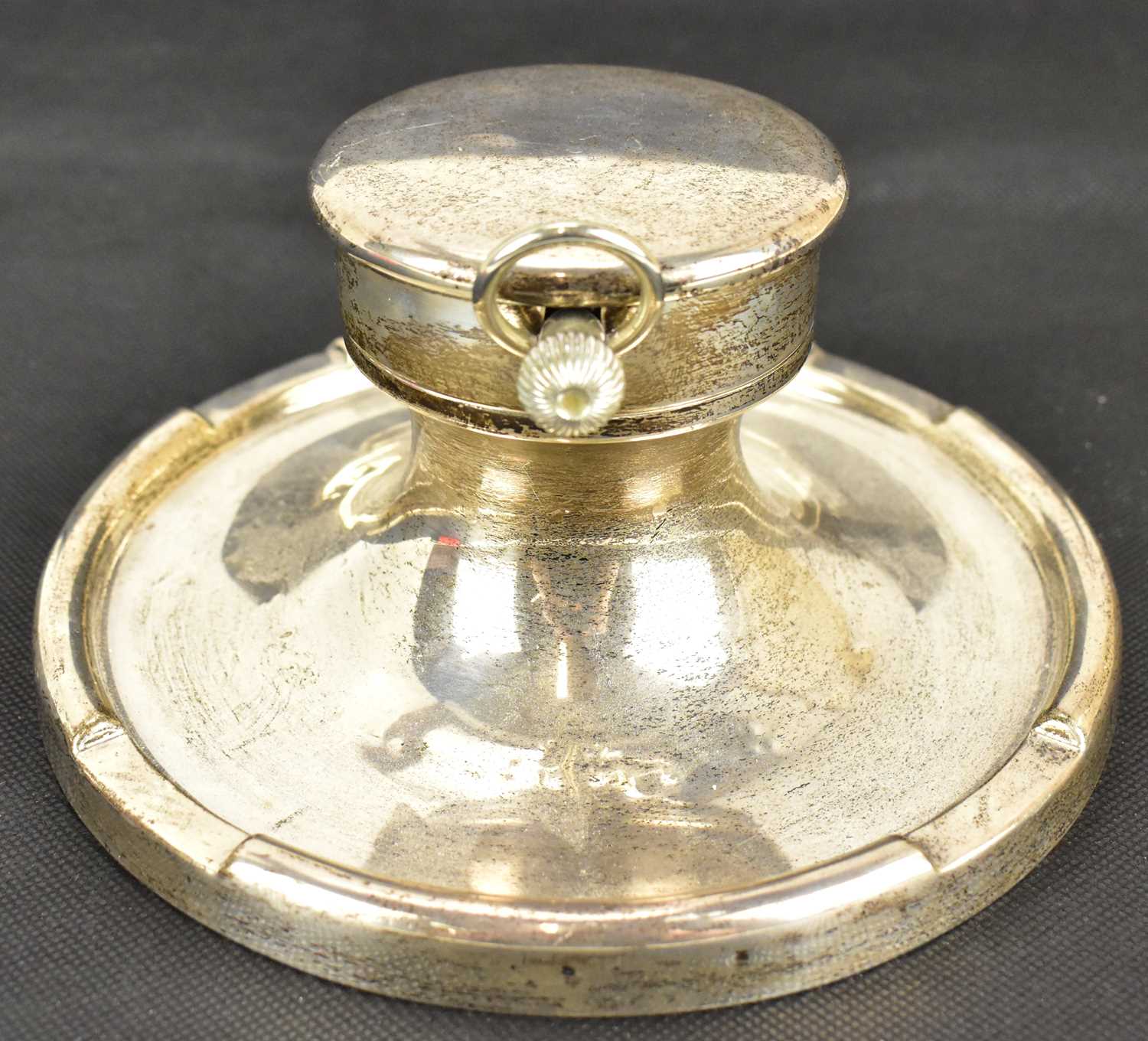Lot 591 - A George V hallmarked silver capstan inkwell,