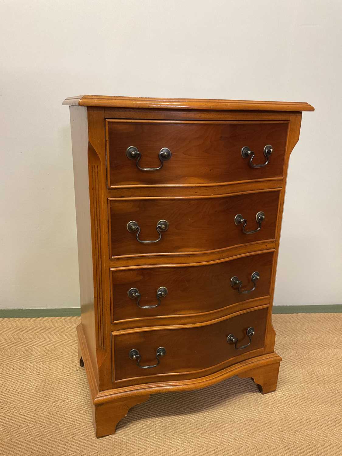 Lot 783 - A small reproduction yew wood serpentine