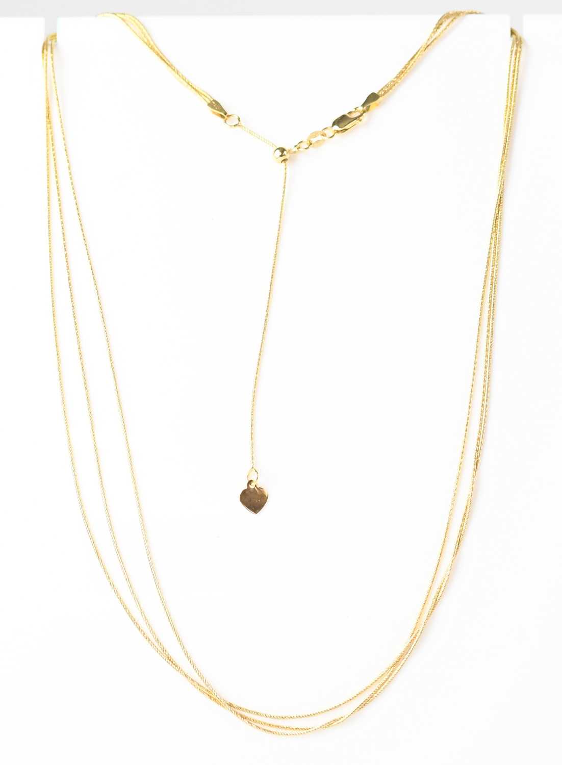 Lot 834 - A 14K yellow gold three-strand snake link