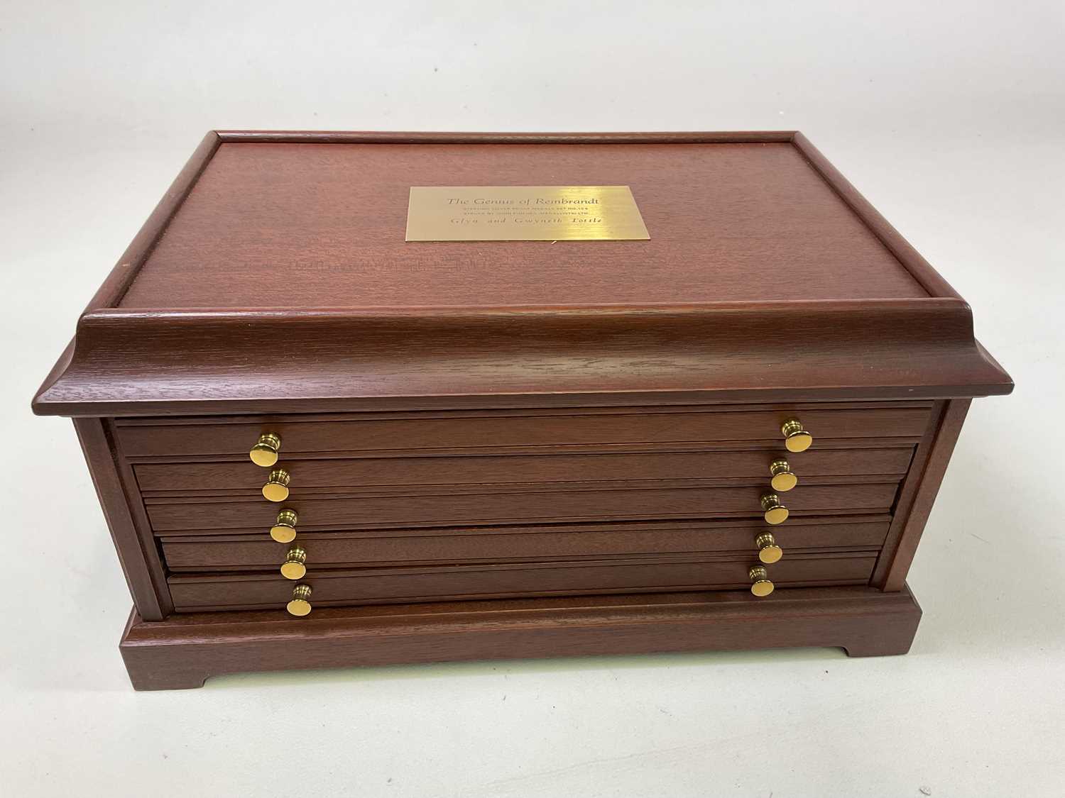 Lot 150 - A five drawer display cabinet bearing plaque