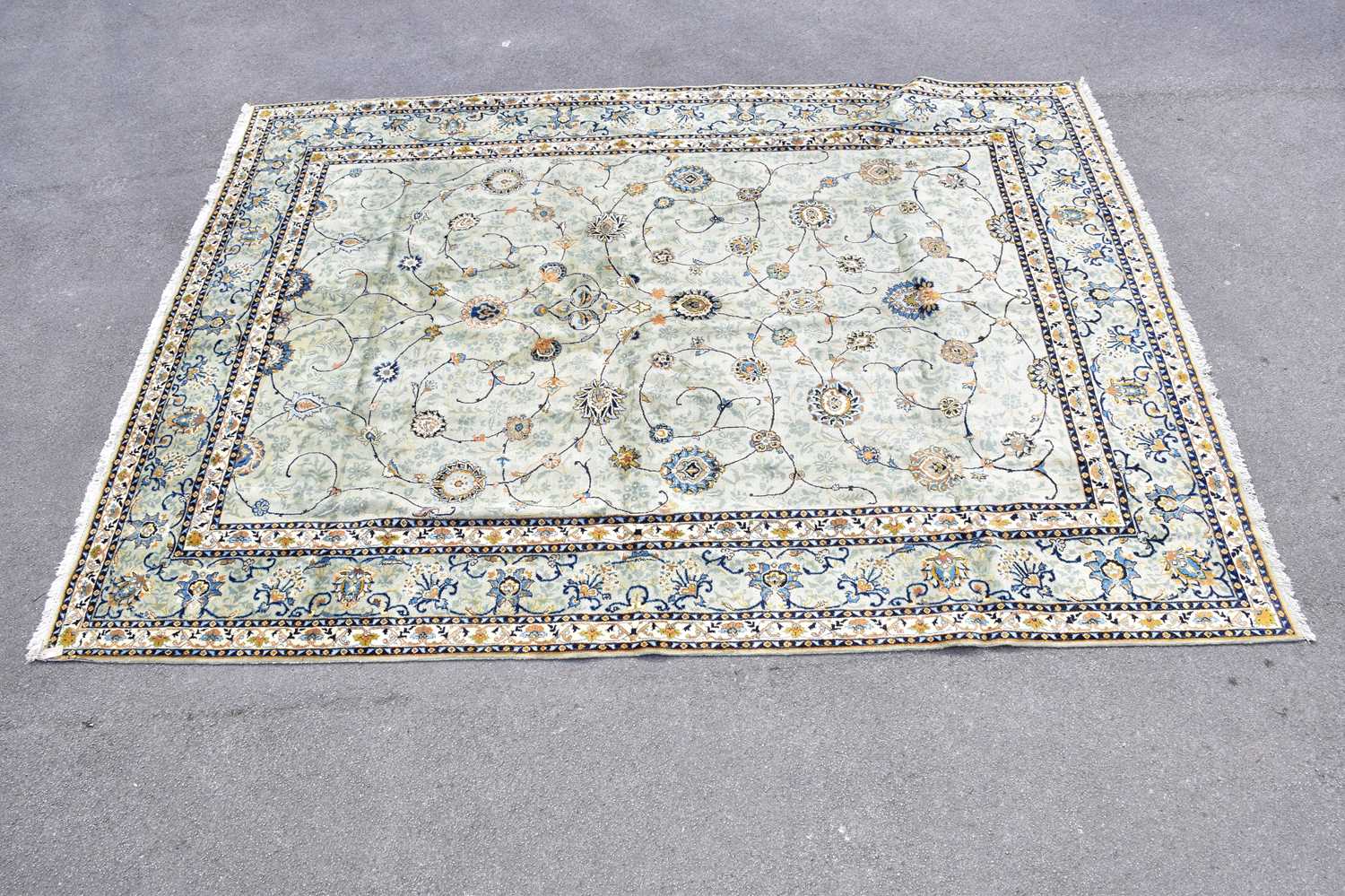 Lot 424 - A pale blue wool carpet with floral pattern,
